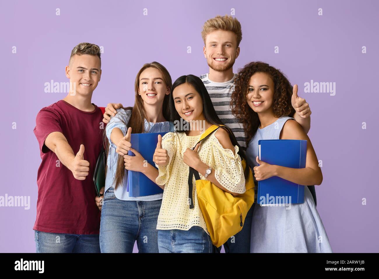 Group of students showing thumb-up gesture on color background Stock ...
