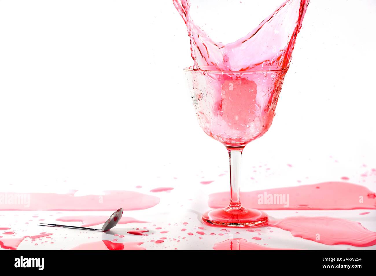 Red alcohol cocktail drink splash on white background Stock Photo - Alamy