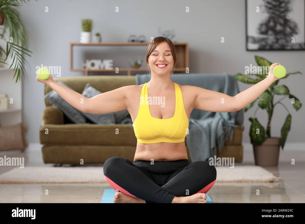 Body positive woman training at home Stock Photo - Alamy