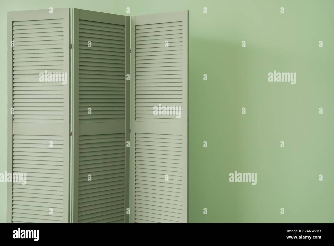 Wooden folding screen on color background Stock Photo - Alamy