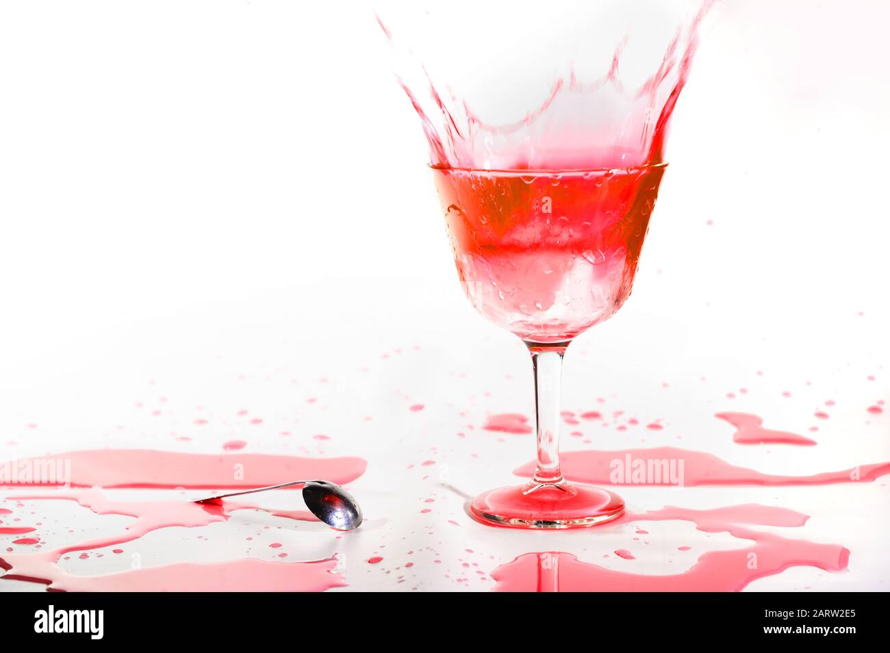 Red alcohol cocktail drink splash on white background Stock Photo - Alamy