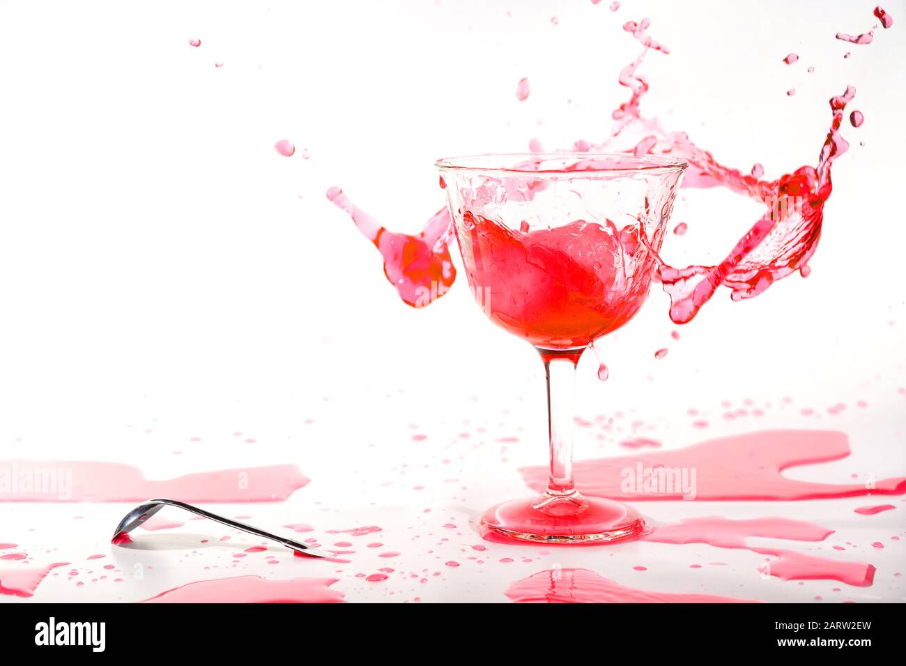 Red alcohol cocktail drink splash on white background Stock Photo - Alamy