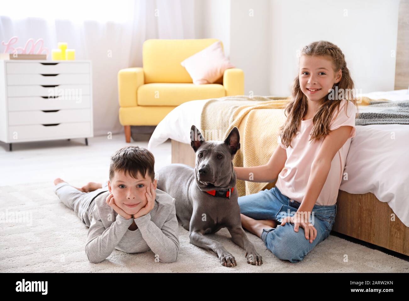 Little children with cute dog at home Stock Photo - Alamy