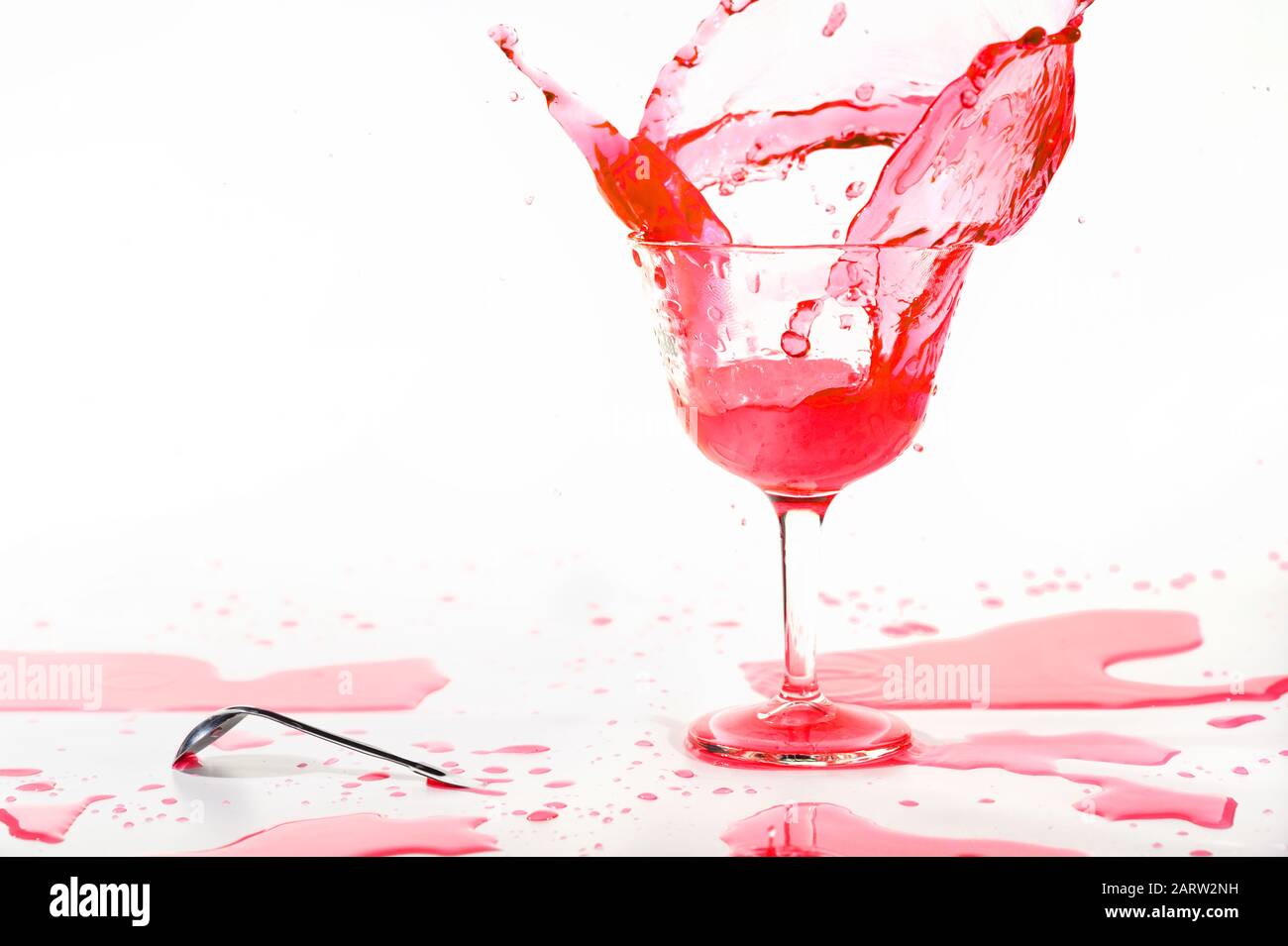 Red alcohol cocktail drink splash on white background Stock Photo - Alamy