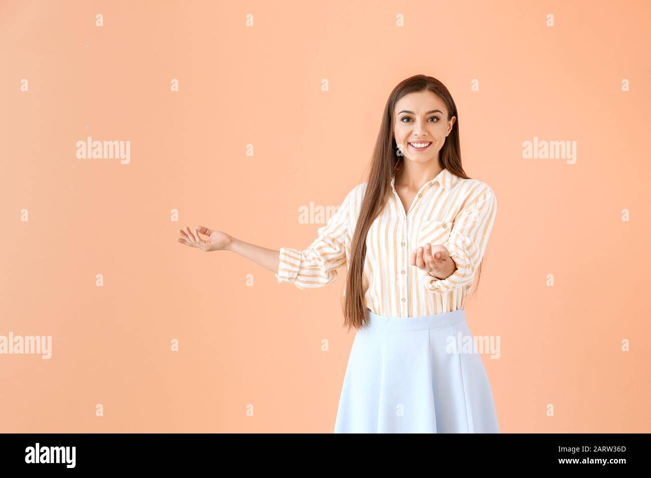 Beautiful woman inviting viewer on color background Stock Photo - Alamy