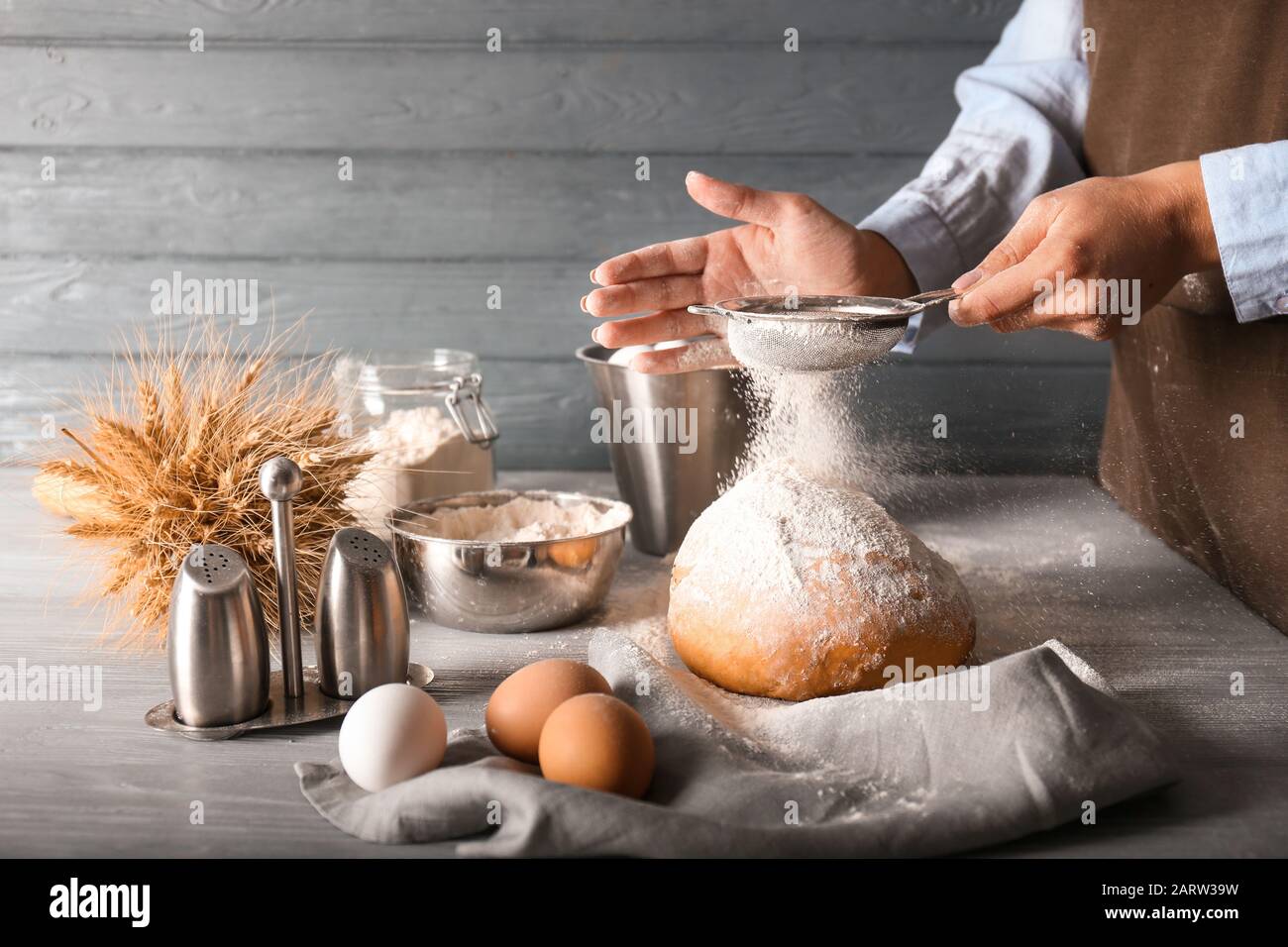 Woman sieving flour in kitchen Stock Photo - Alamy