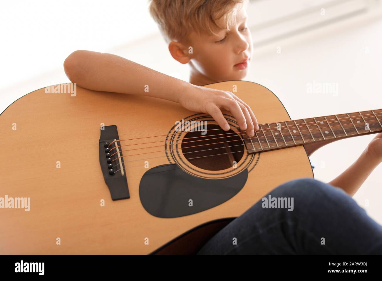 Little boy playing guitar at home Stock Photo - Alamy