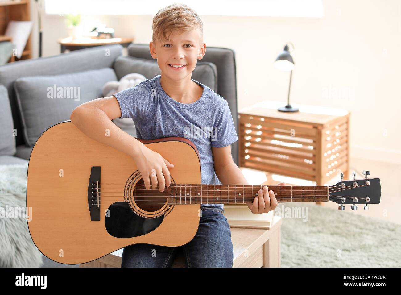 Little boy playing guitar at home Stock Photo - Alamy