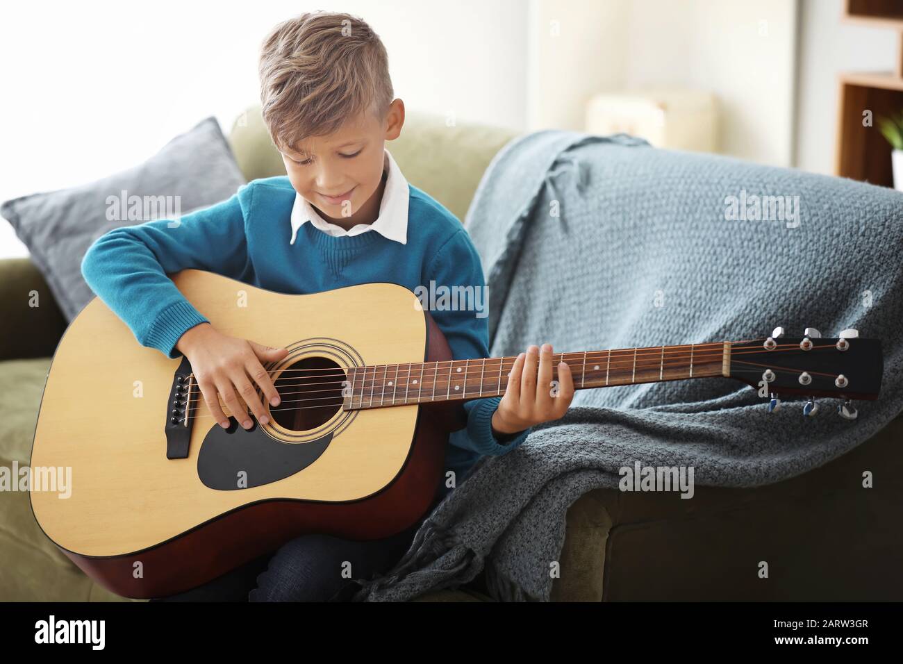Little boy playing guitar at home Stock Photo - Alamy