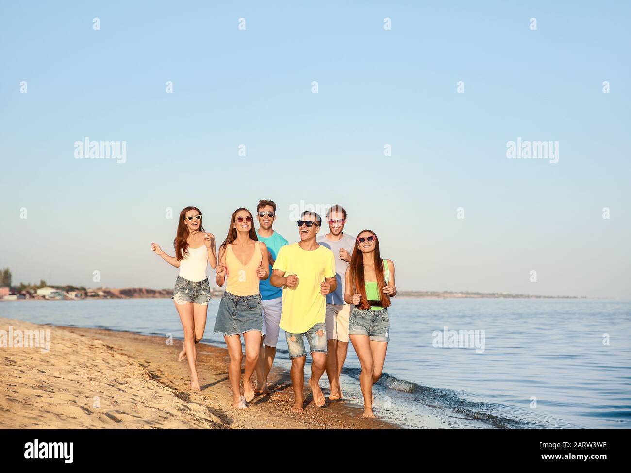 Female friends sunbathing on the beach hi-res stock photography and ...