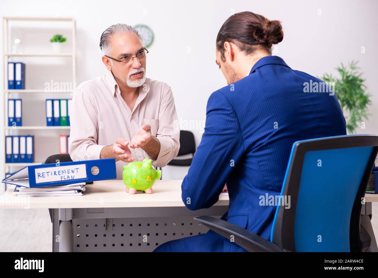 The financial advisor giving retirement advice to old man Stock Photo ...