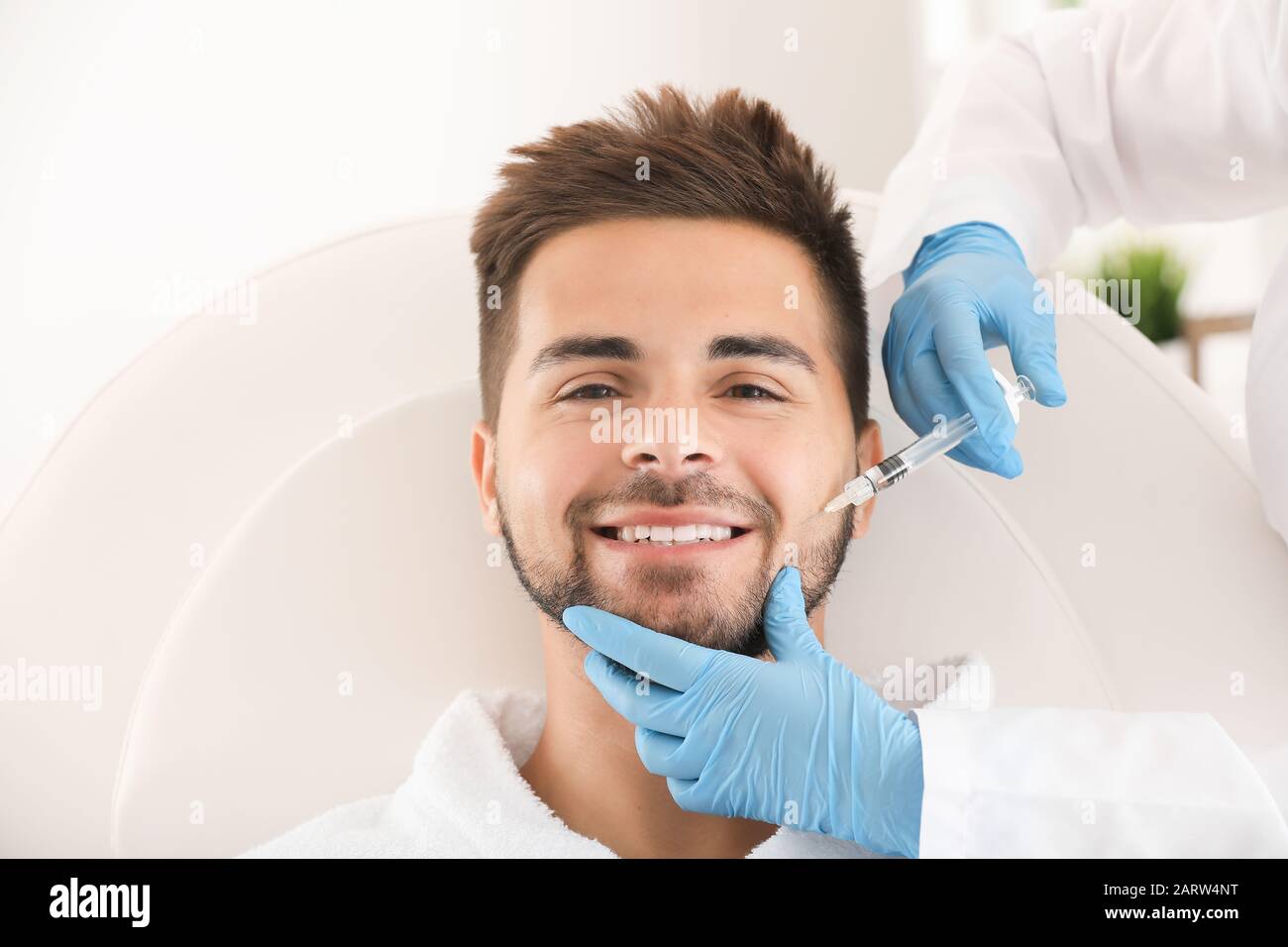 Handsome woman receiving injection in hi-res stock photography and ...