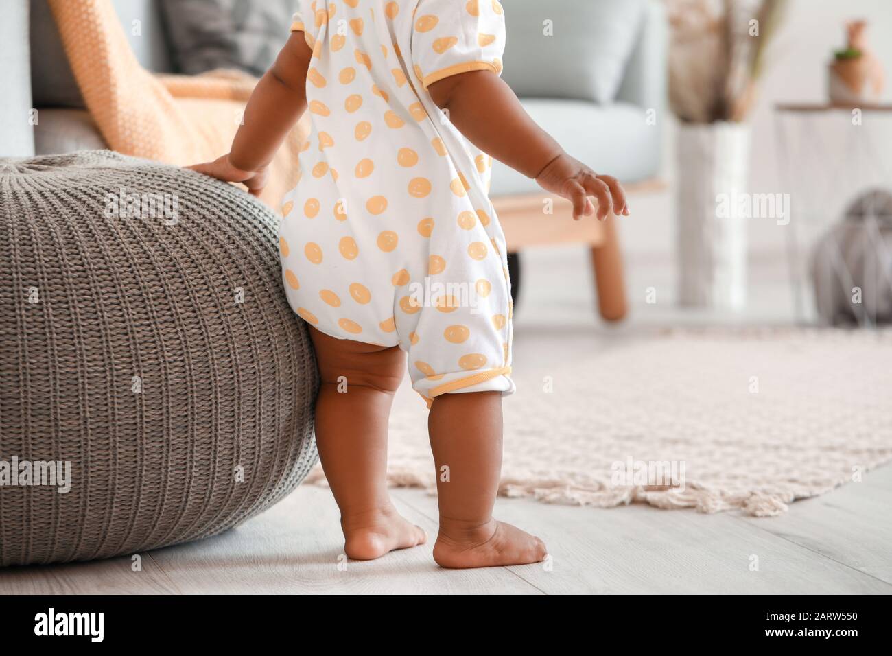 Cute little baby learning to walk at home Stock Photo - Alamy