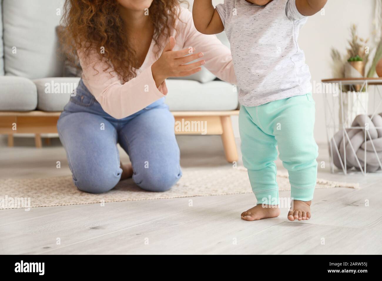 Cute little baby learning to walk at home Stock Photo - Alamy