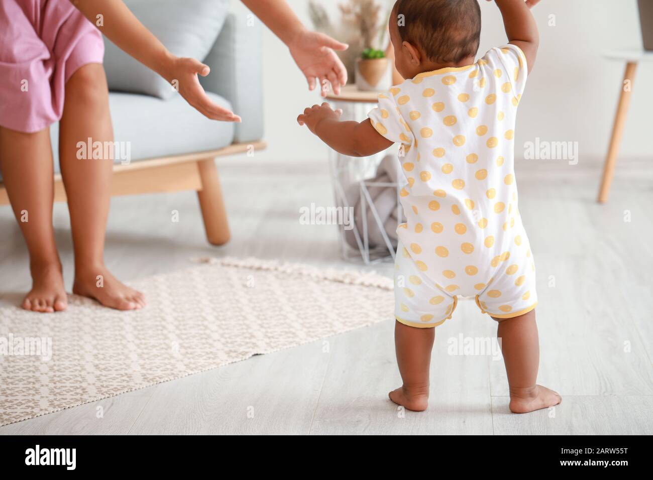 Cute little baby learning to walk at home Stock Photo - Alamy