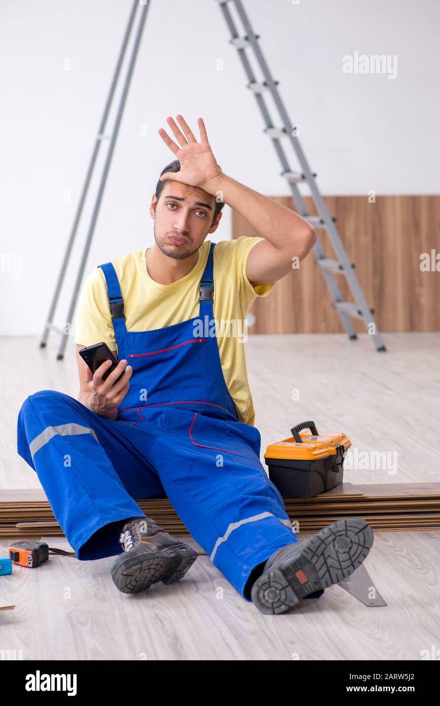 The young male contractor working indoors Stock Photo - Alamy