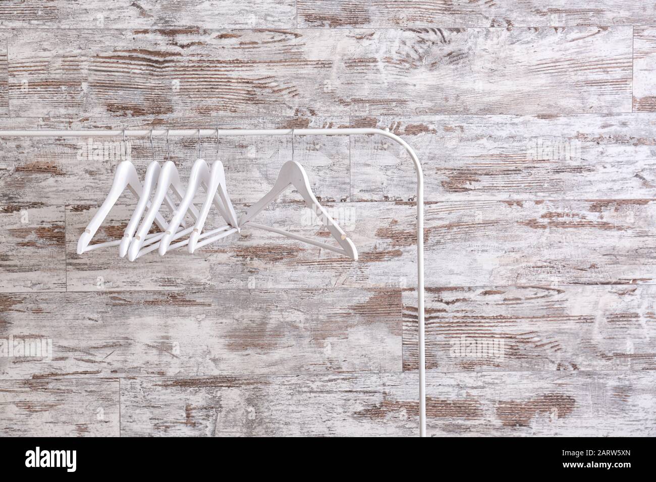 Clothing rack against wall hi-res stock photography and images - Alamy