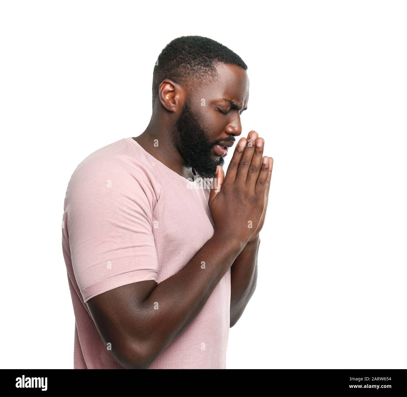 Praying African-American man on white background Stock Photo - Alamy