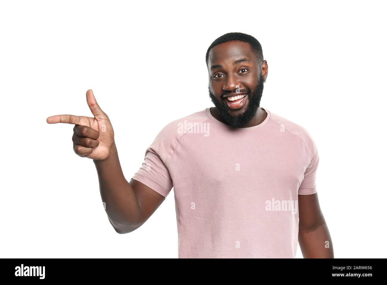 Handsome African-American man pointing at something on white background ...