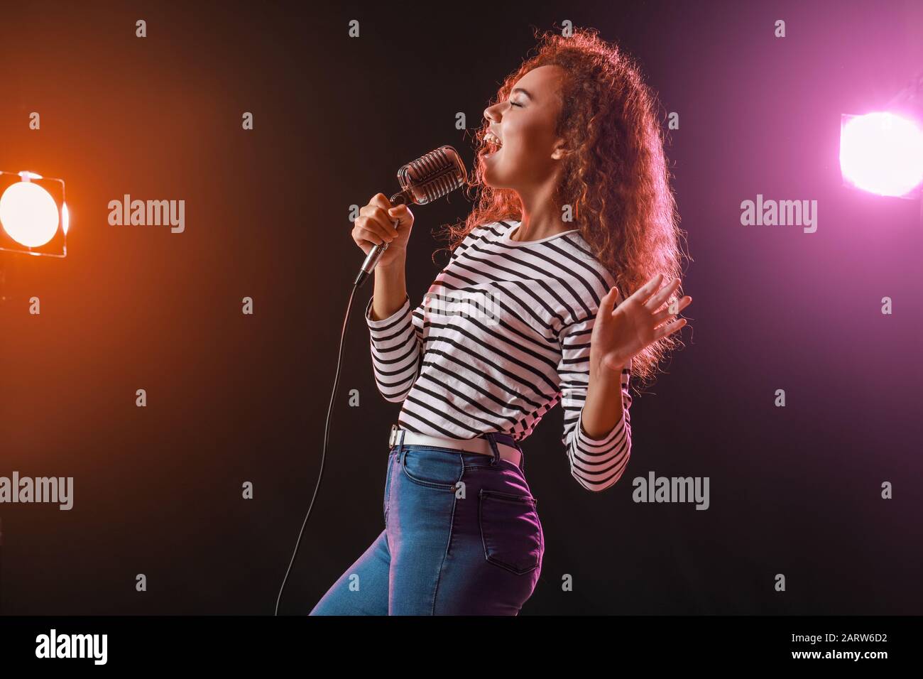 Beautiful African-American female singer with microphone on stage Stock ...