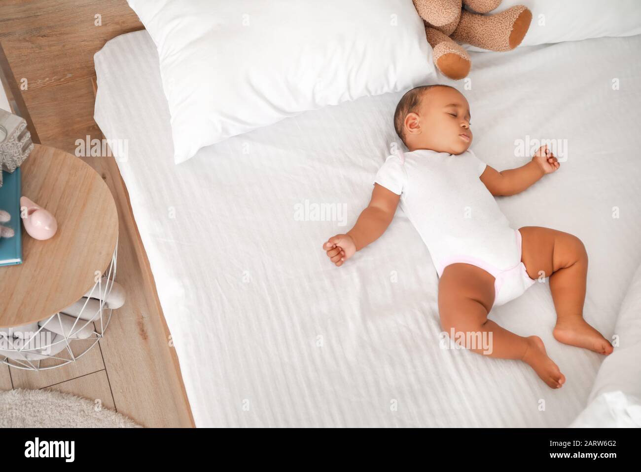 Cute African-American baby sleeping on bed Stock Photo - Alamy