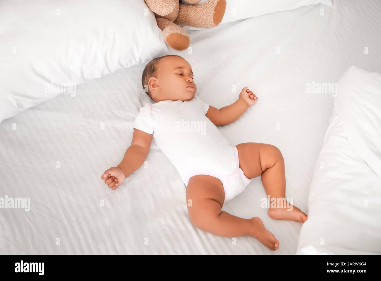 Cute African-American baby sleeping on bed Stock Photo - Alamy
