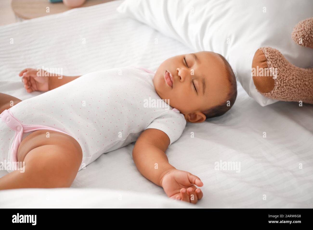 Cute African-American baby sleeping on bed Stock Photo - Alamy