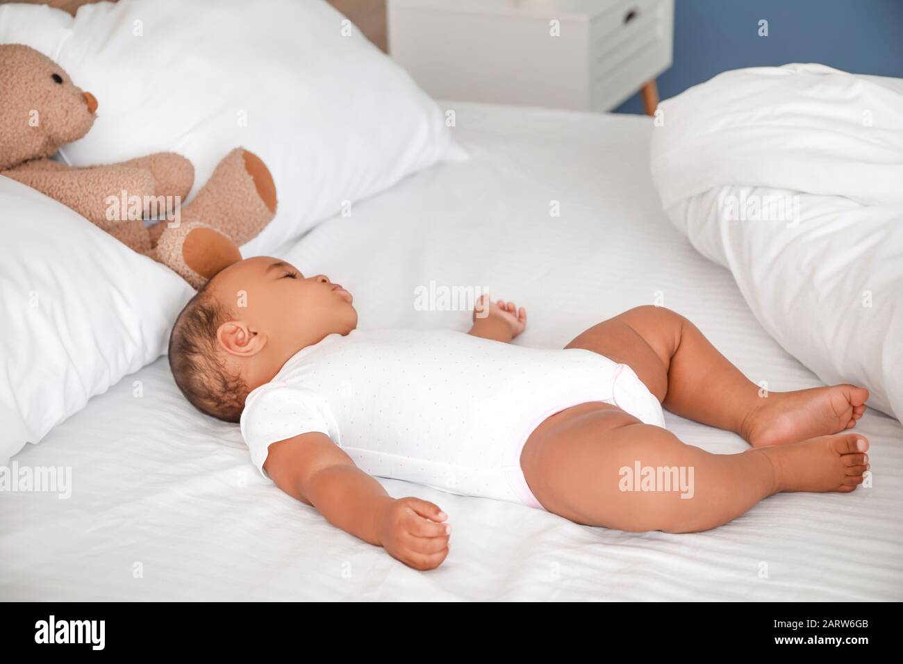 Cute African-American baby sleeping on bed Stock Photo - Alamy