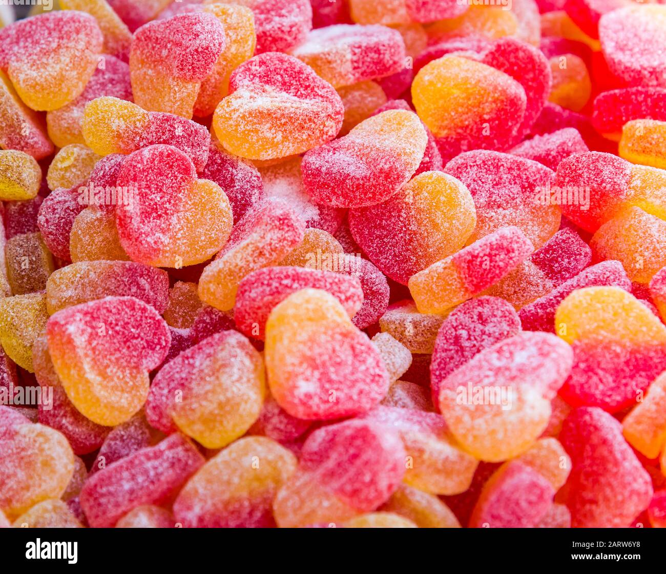 Colorful sugary candy heart shape background Colored jelly candies ...