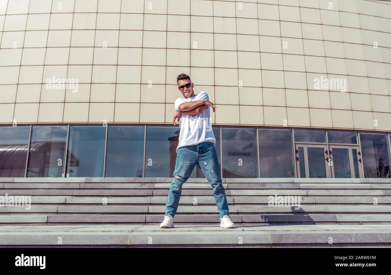 happy man smiles, young guy dancer, in summer in city, dancing street ...