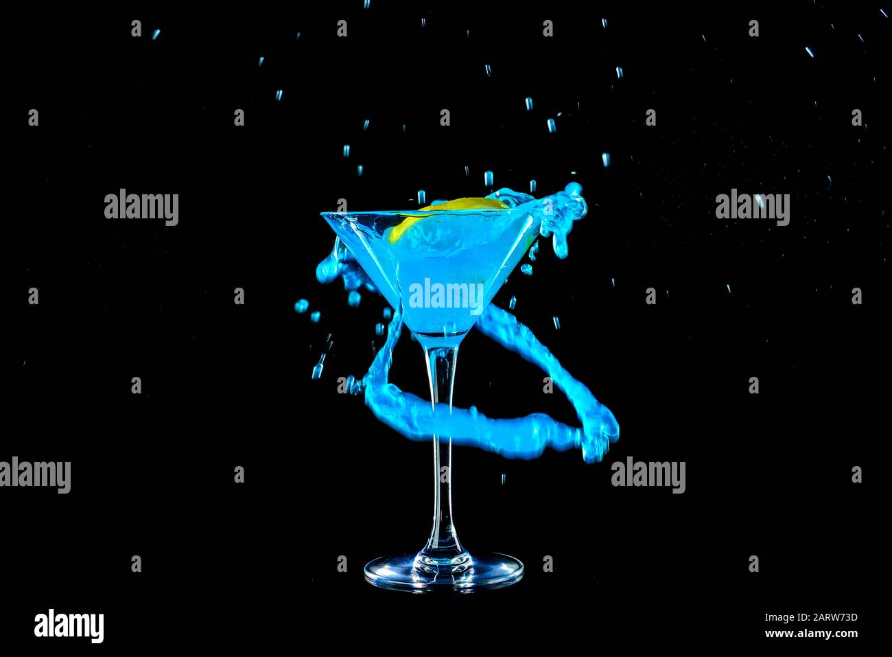 Glass of tasty cocktail with splash on dark background Stock Photo - Alamy