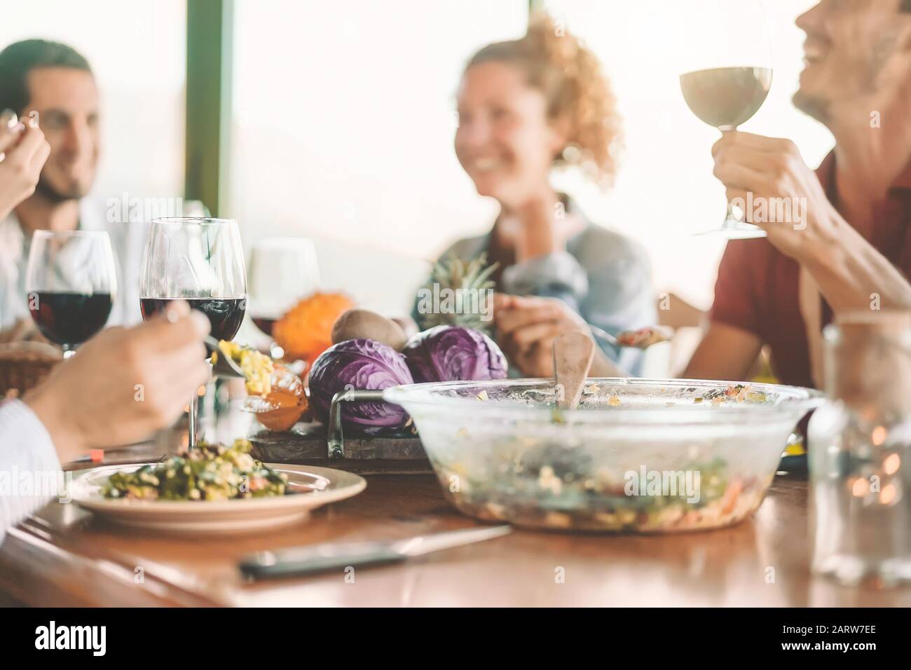 Happy friends eating vegetarian food and drinking red wine - Vegan ...