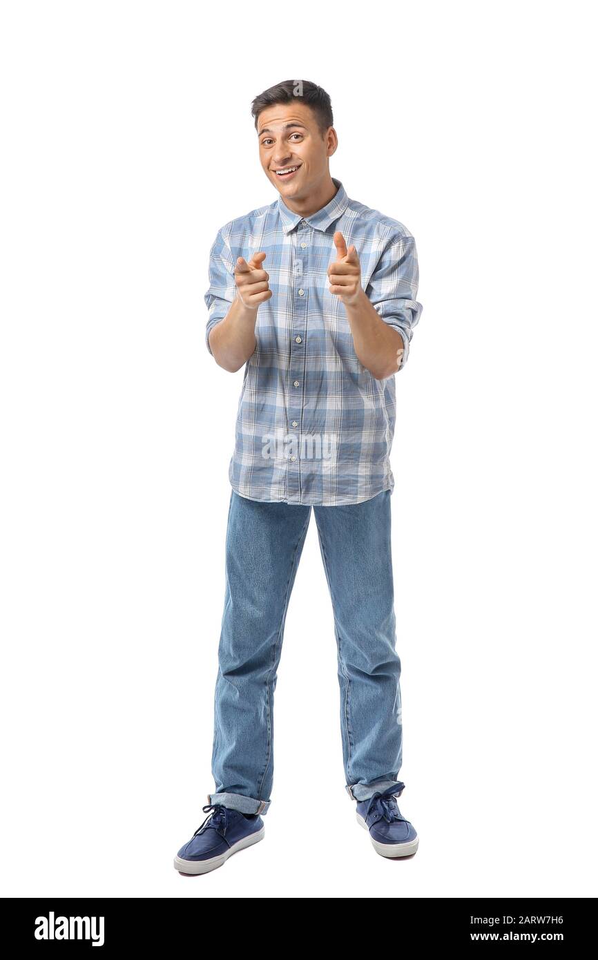 Portrait of handsome young man pointing at viewer on white background ...