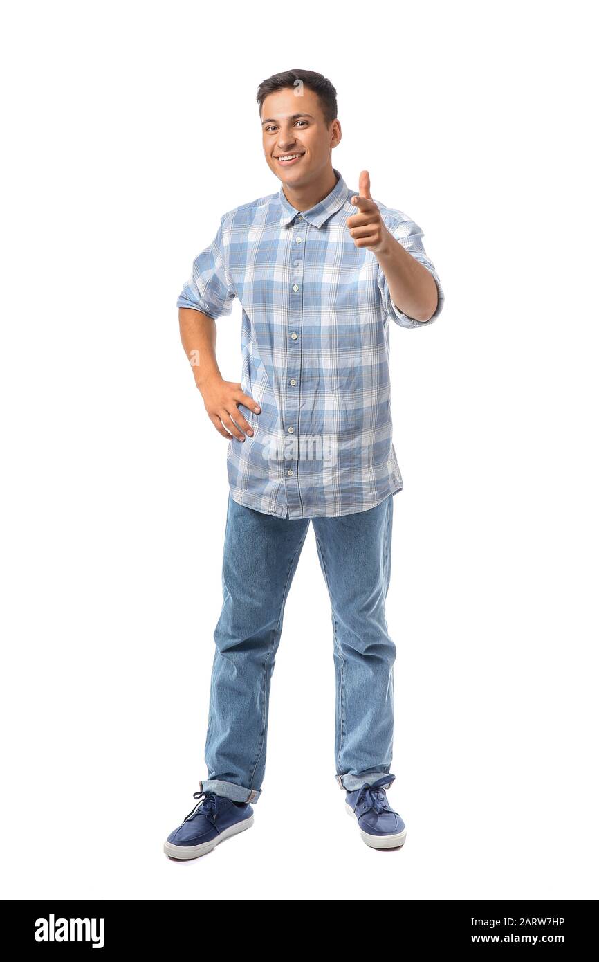 Portrait of handsome young man pointing at viewer on white background ...
