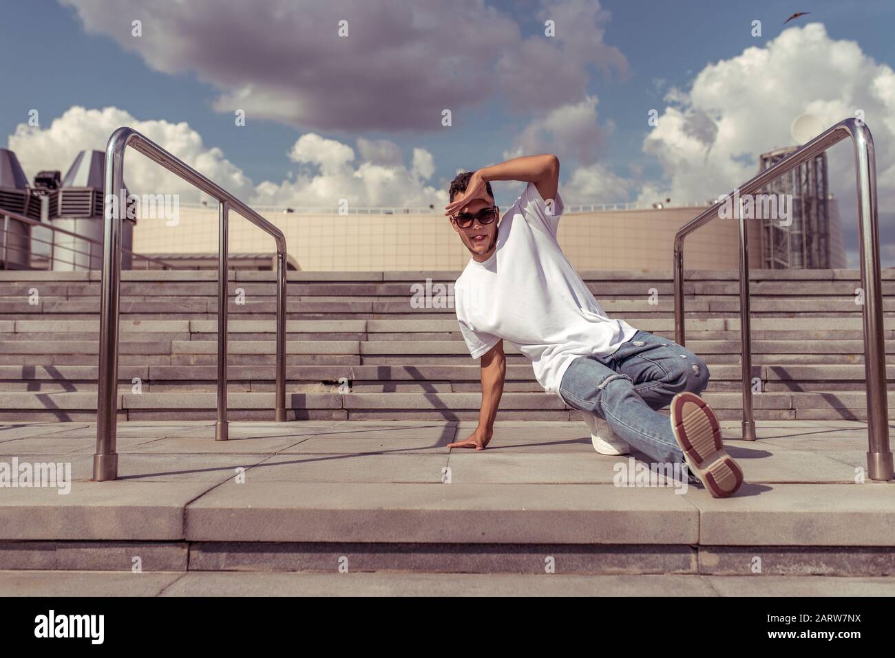 dancer is young guy, in summer in city, dancing street dances, break ...