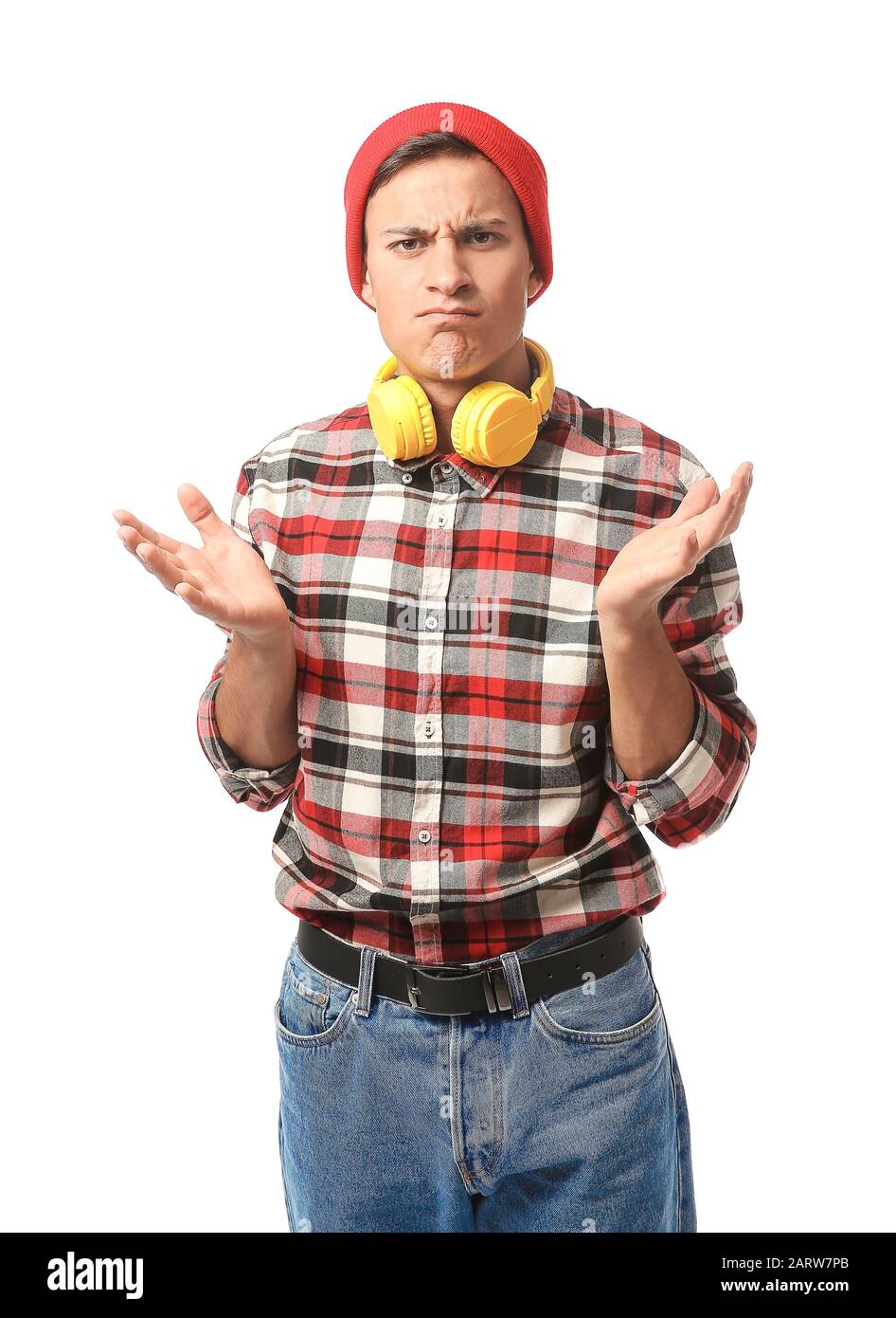 Portrait of displeased young man with headphones on white background ...
