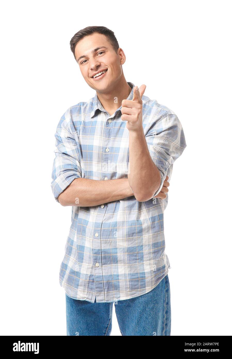 Portrait of handsome young man pointing at viewer on white background ...