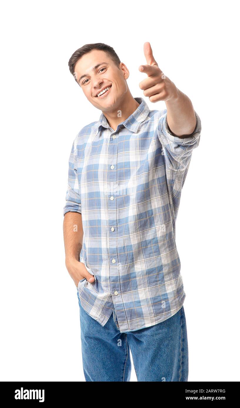 Portrait of handsome young man pointing at viewer on white background ...
