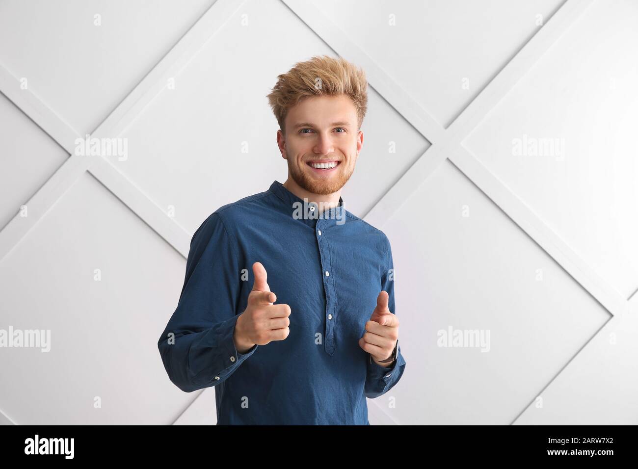 Positive young man pointing viewer hi-res stock photography and images ...