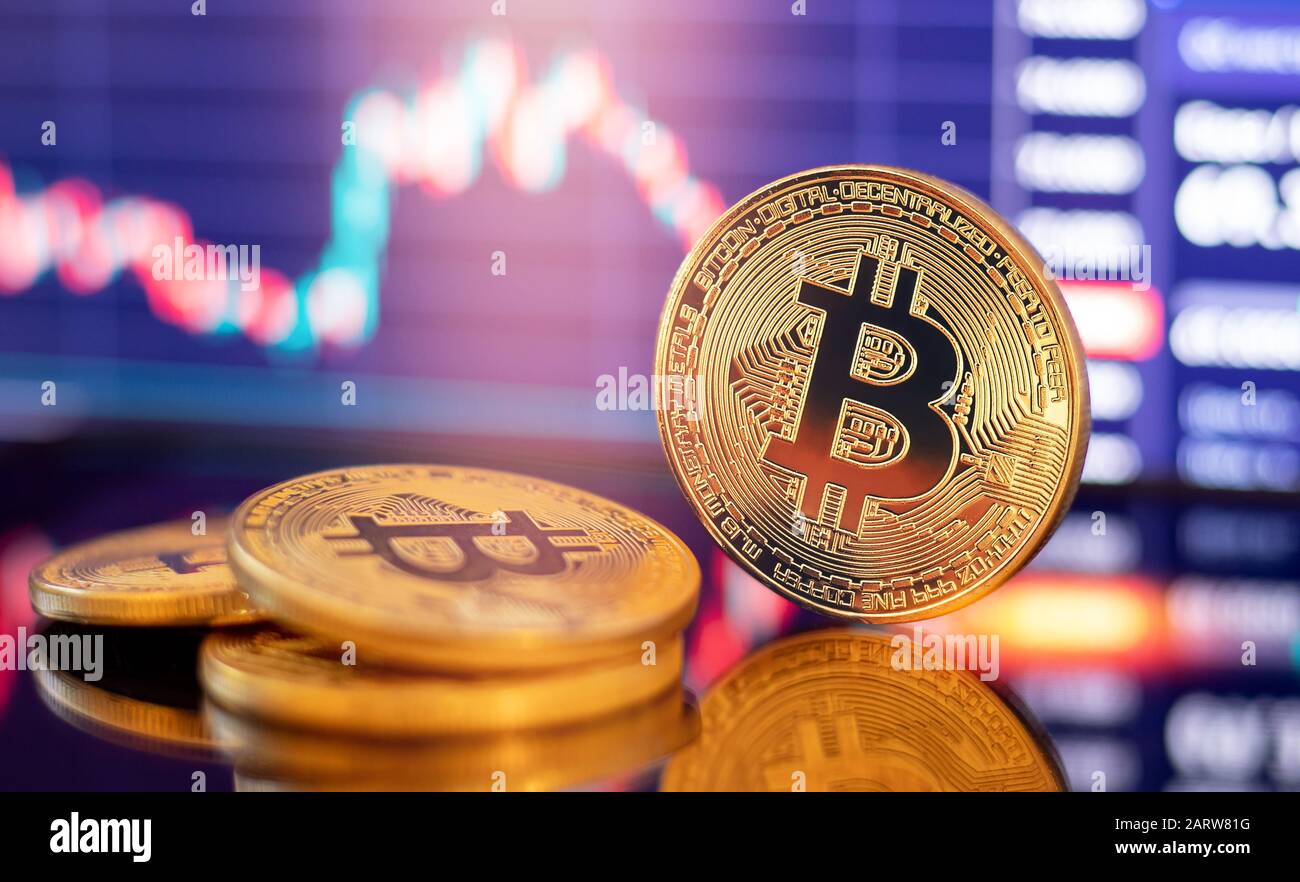 Gold Bitcoin crypto currency on background of red candles chart diagram ...