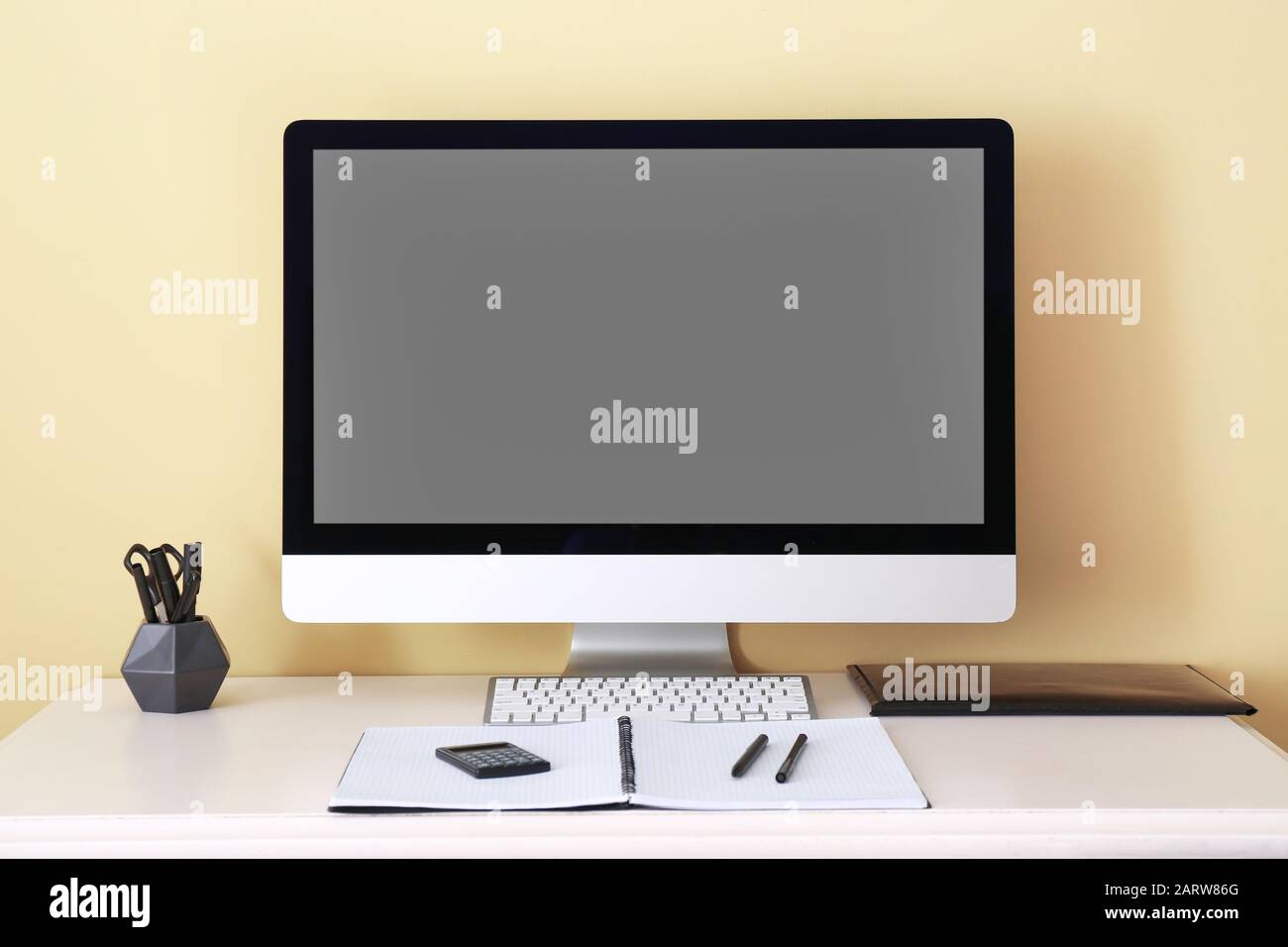 Modern workplace with computer near color wall Stock Photo - Alamy