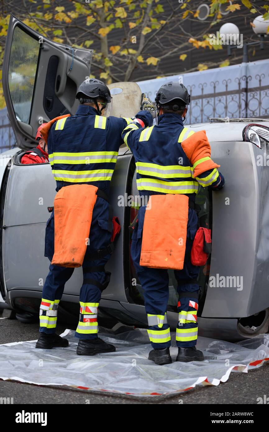 Rescue intervention team trying to save a victim from a car accident ...