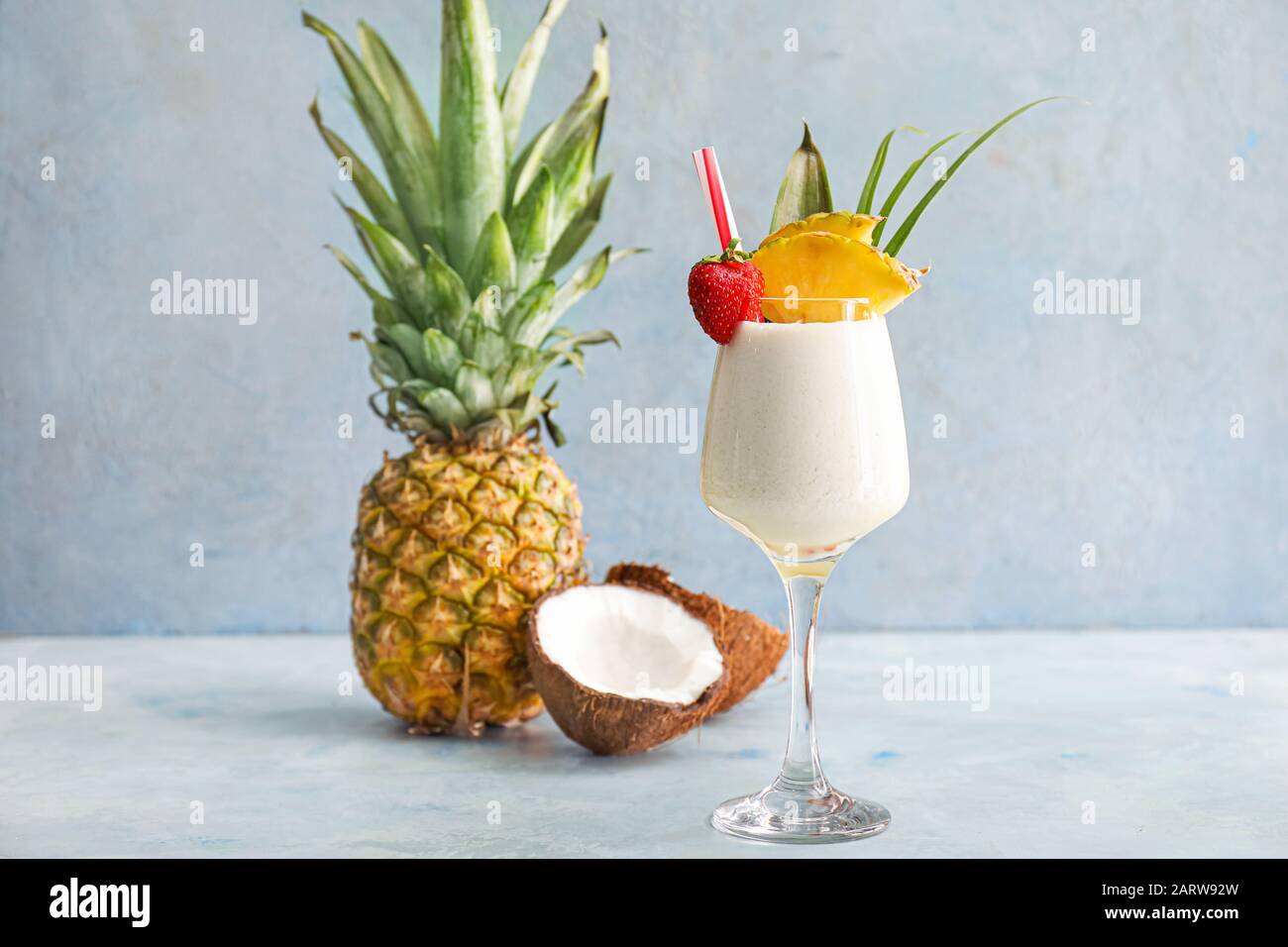 Glass of tasty Pina Colada cocktail and fruits on table Stock Photo - Alamy