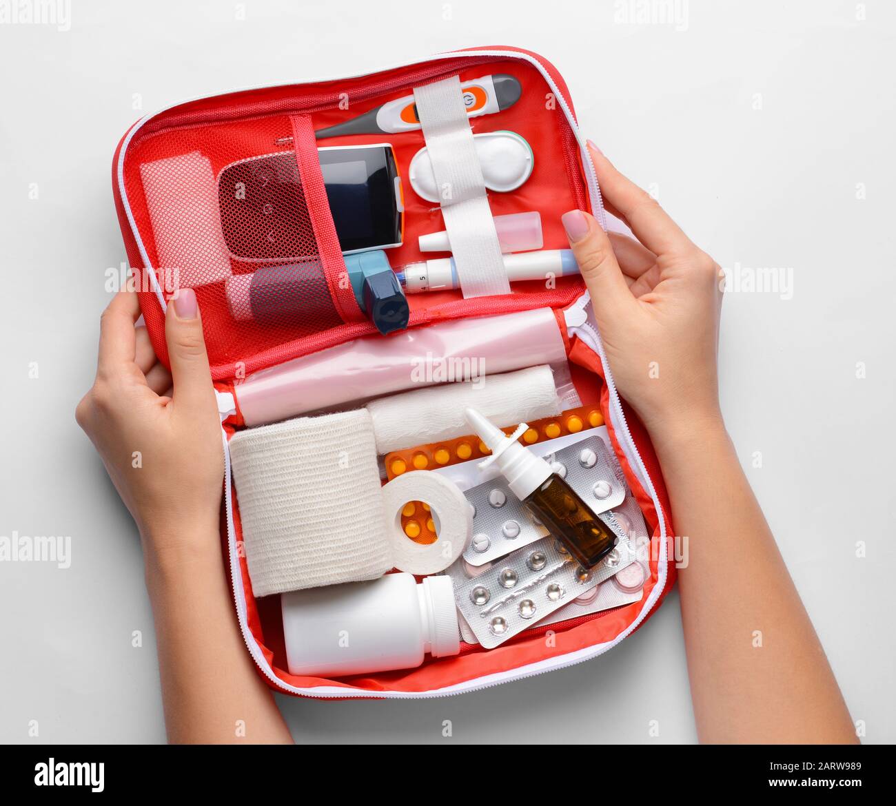 Female hands with first aid kit on white background Stock Photo - Alamy