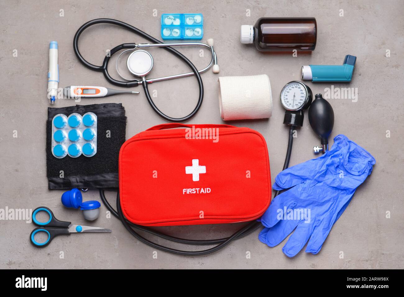 First aid kit on grey background Stock Photo - Alamy