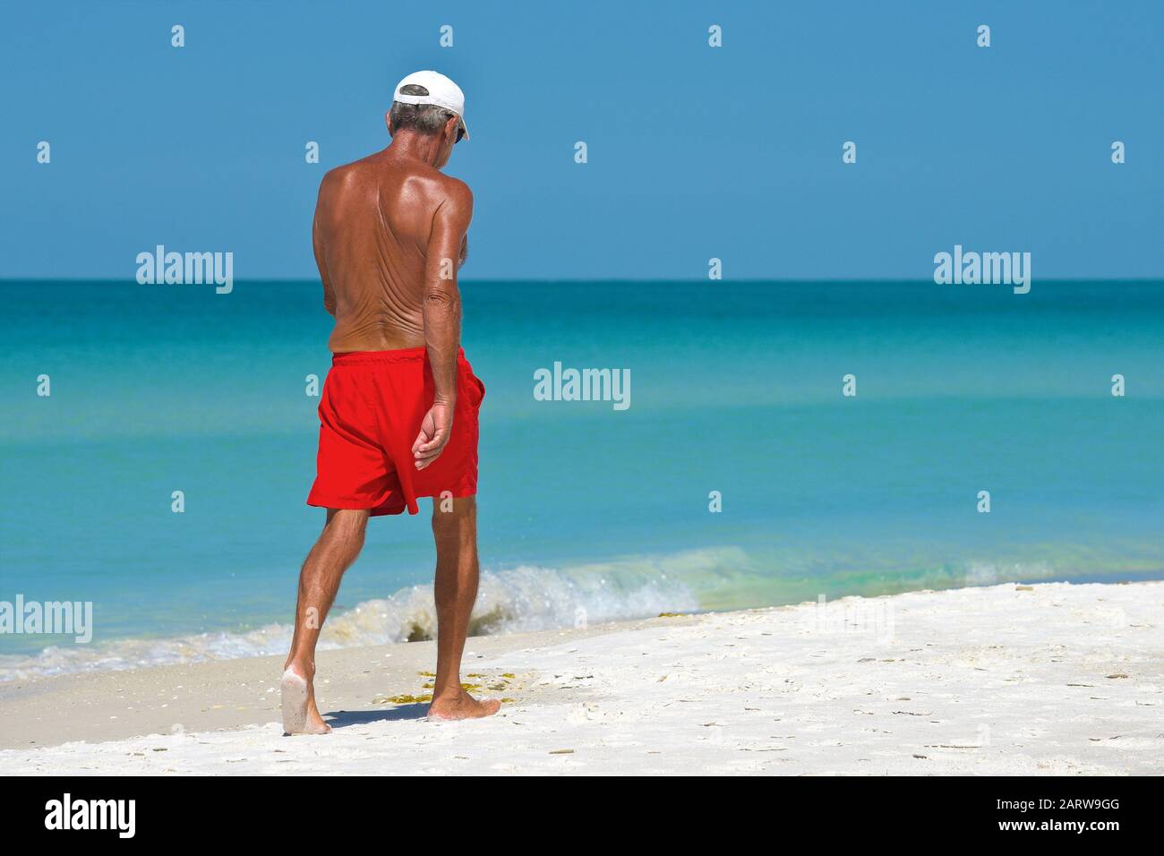 HOLMES BEACH, ANNA MARIA ISLAND, FL - May 1, 2018: Older Man walking on ...
