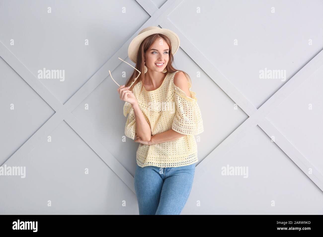 Beautiful young woman on light background Stock Photo - Alamy