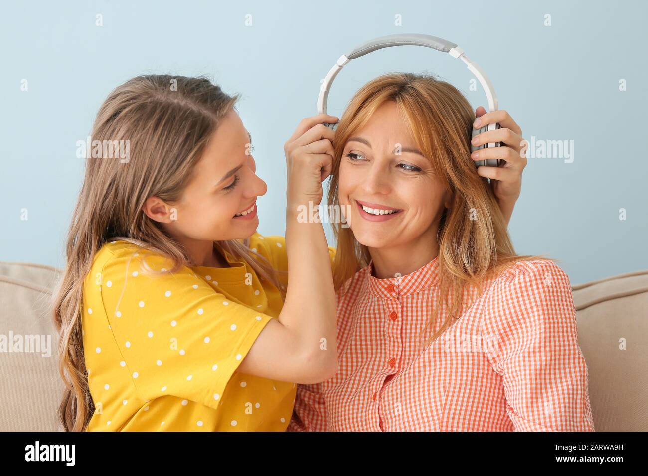 Happy mother and daughter listening to music at home Stock Photo - Alamy