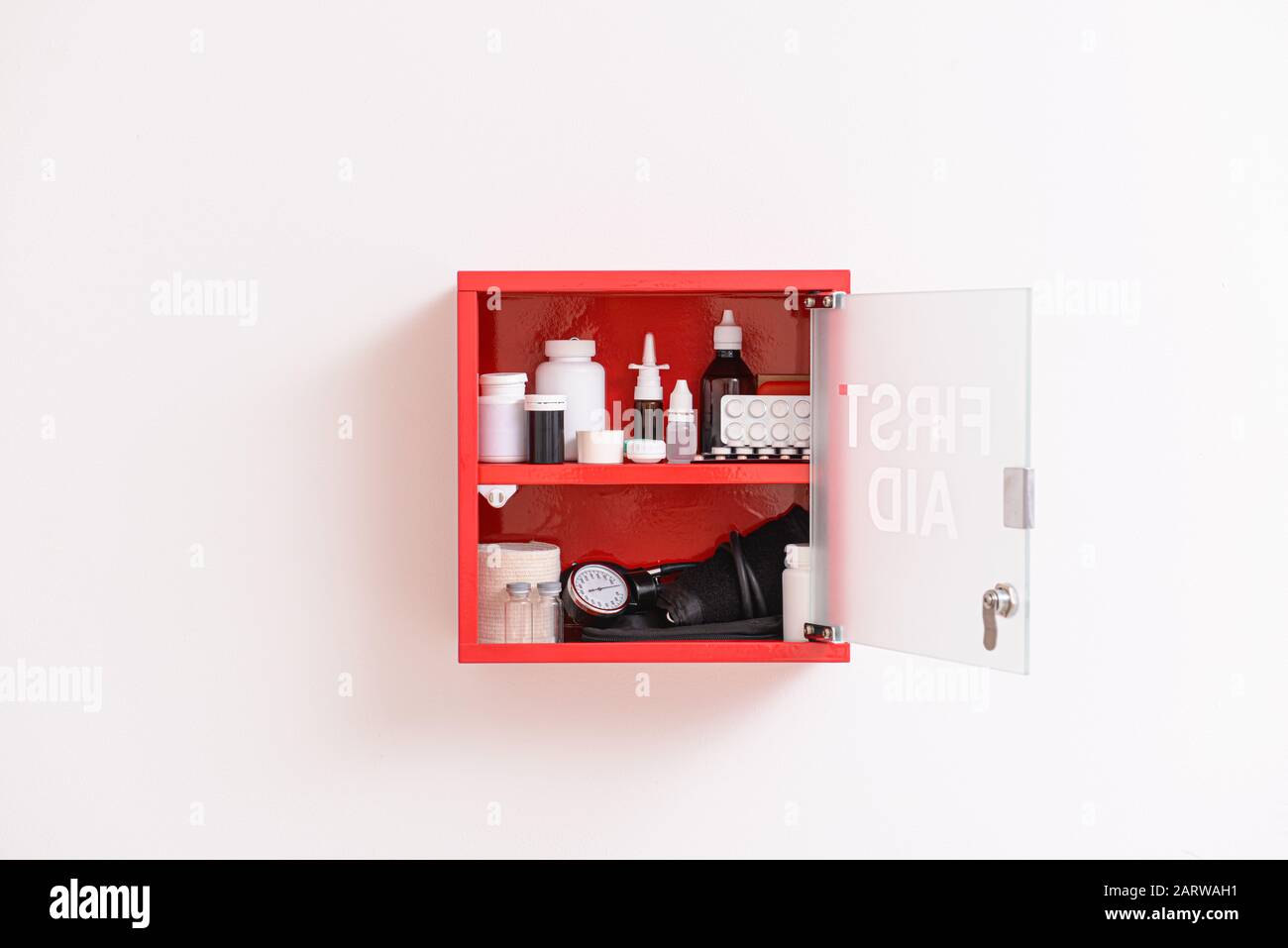 Wall mounted first aid kit on light background Stock Photo - Alamy
