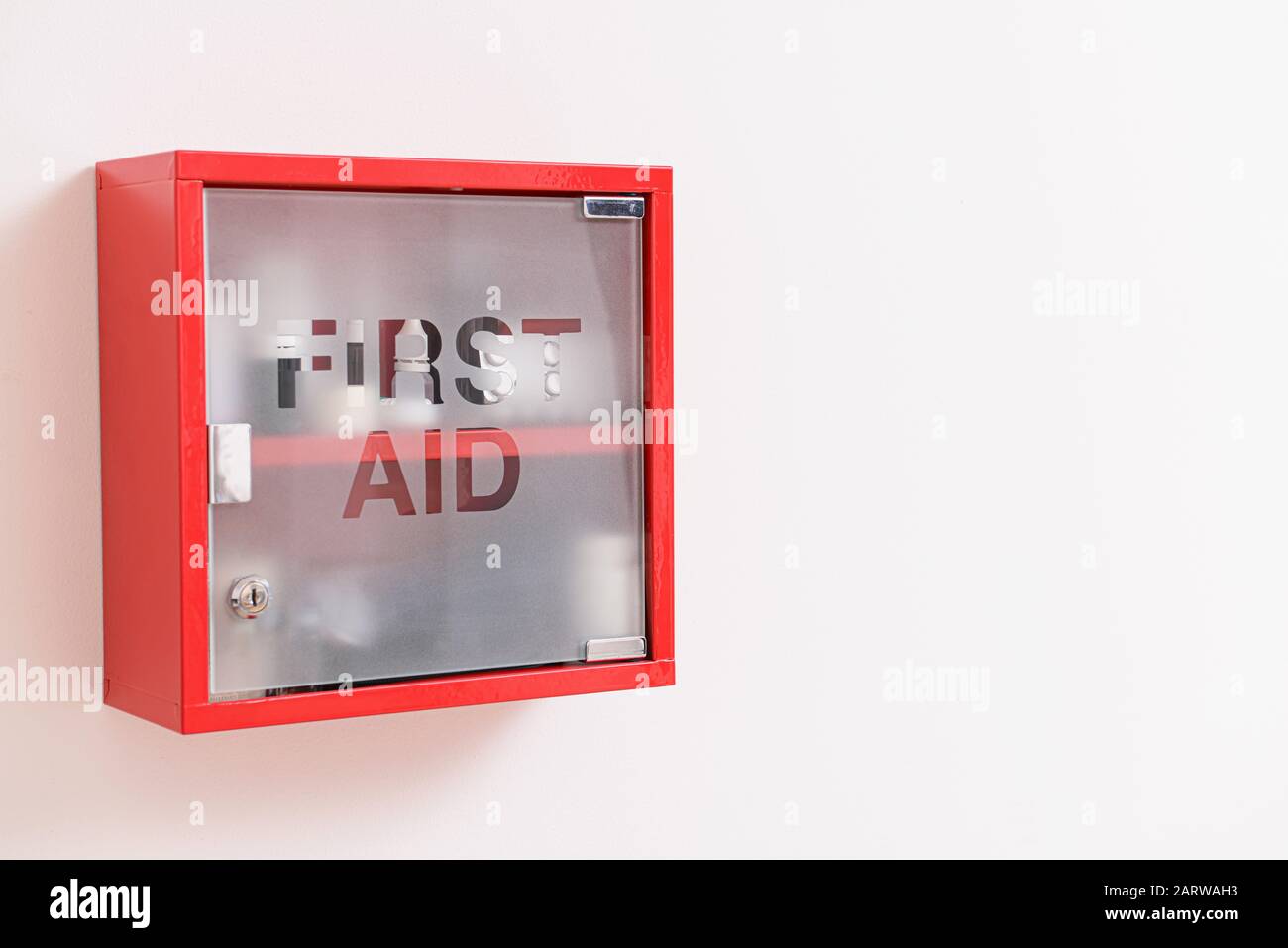 Wall mounted first aid kit on light background Stock Photo - Alamy
